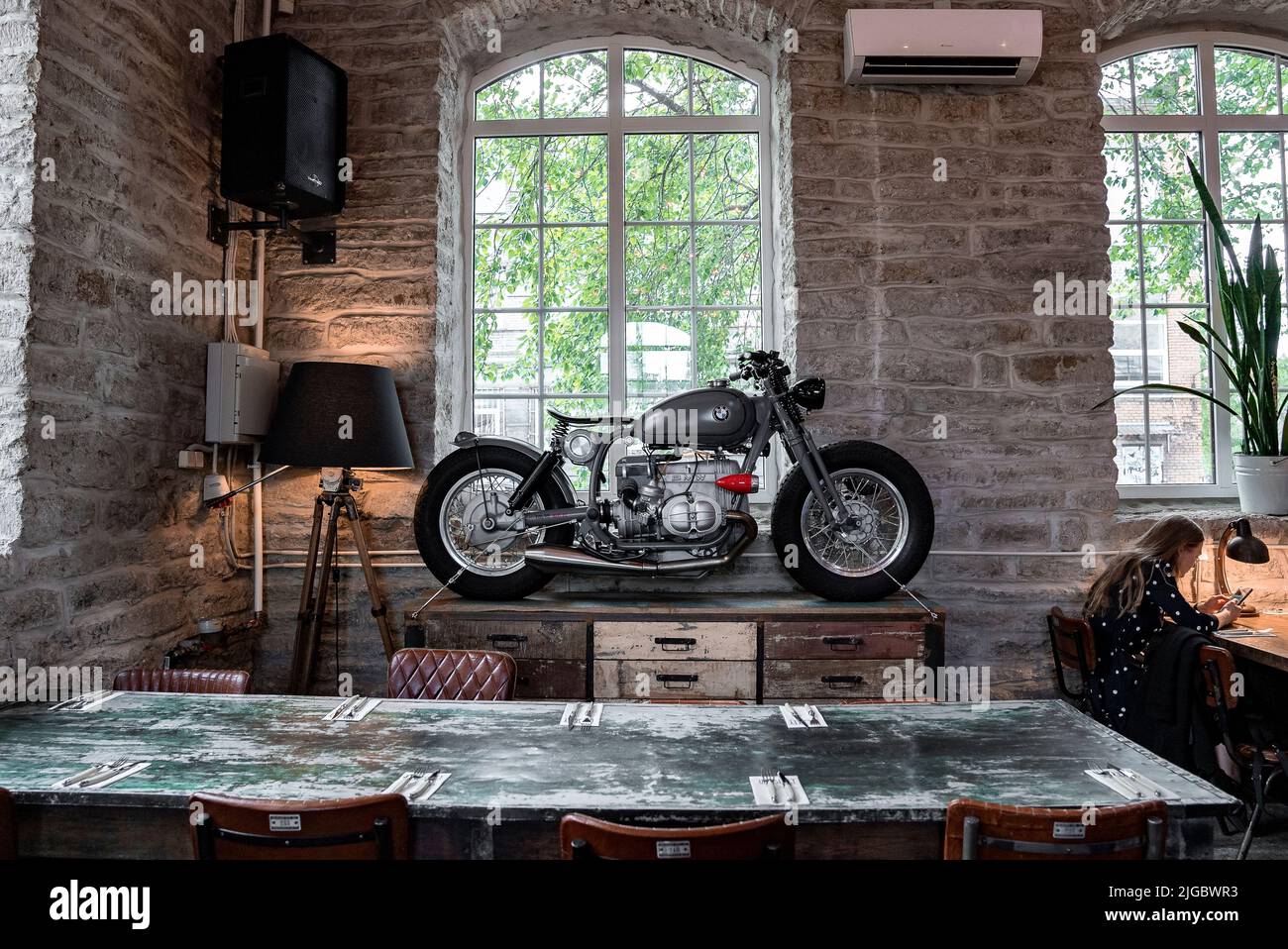 Motorcycle on weathered table against window inside famous One sixty ...