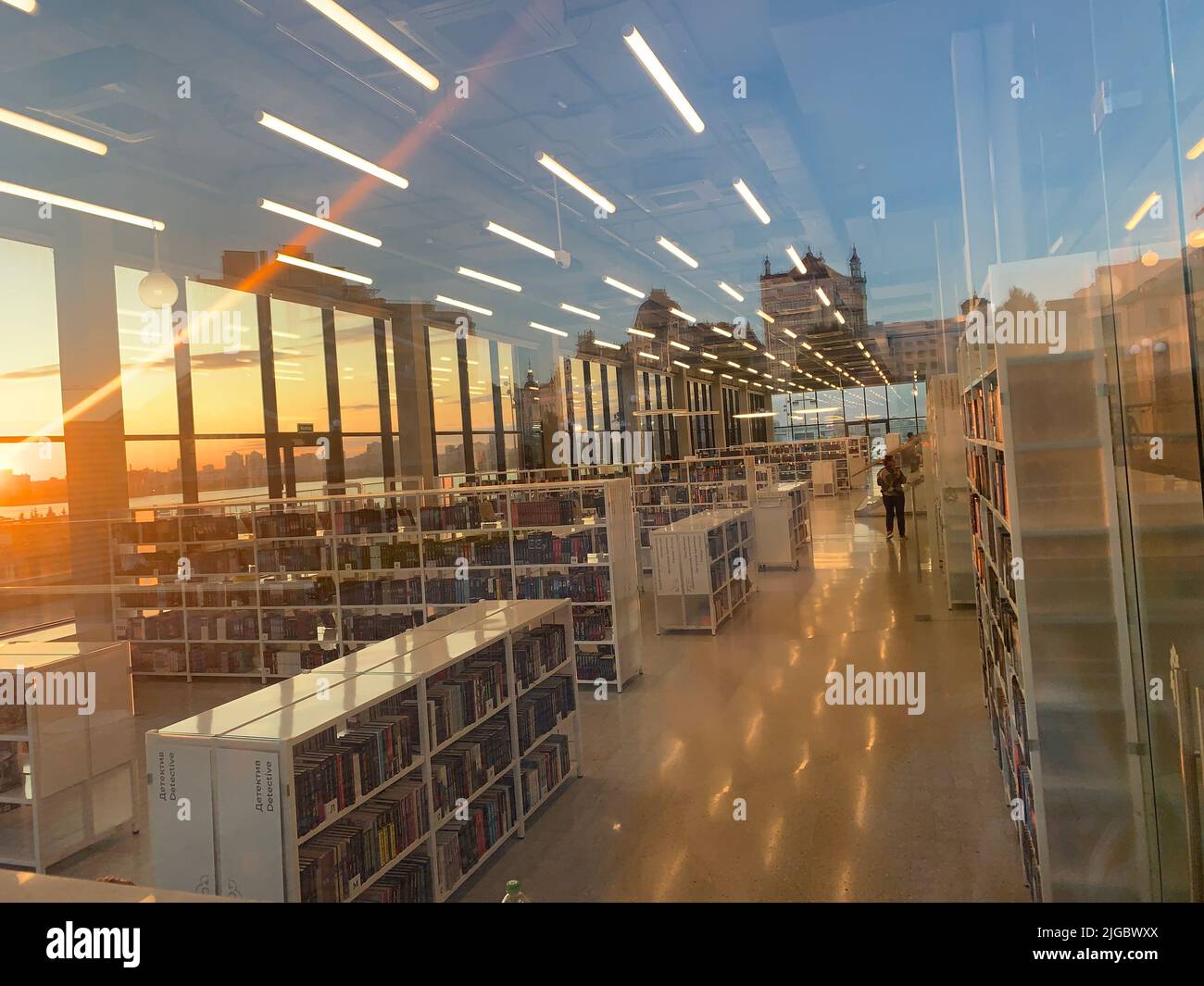 Modern library in sunlight with big window Stock Photo - Alamy