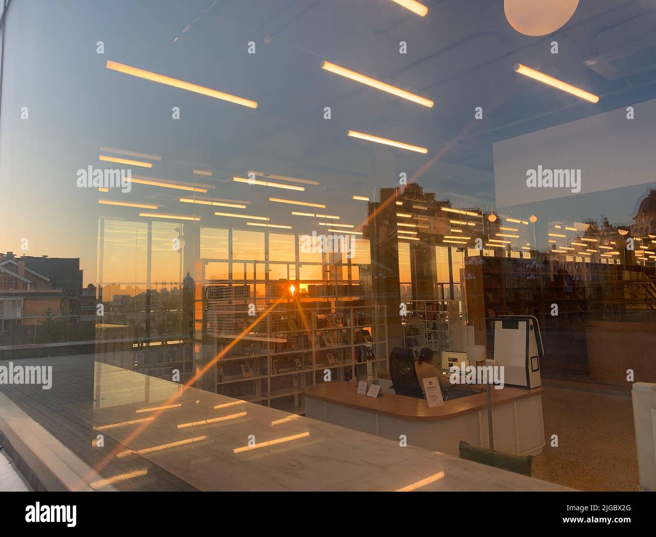 Modern library in sunlight with big window Stock Photo - Alamy