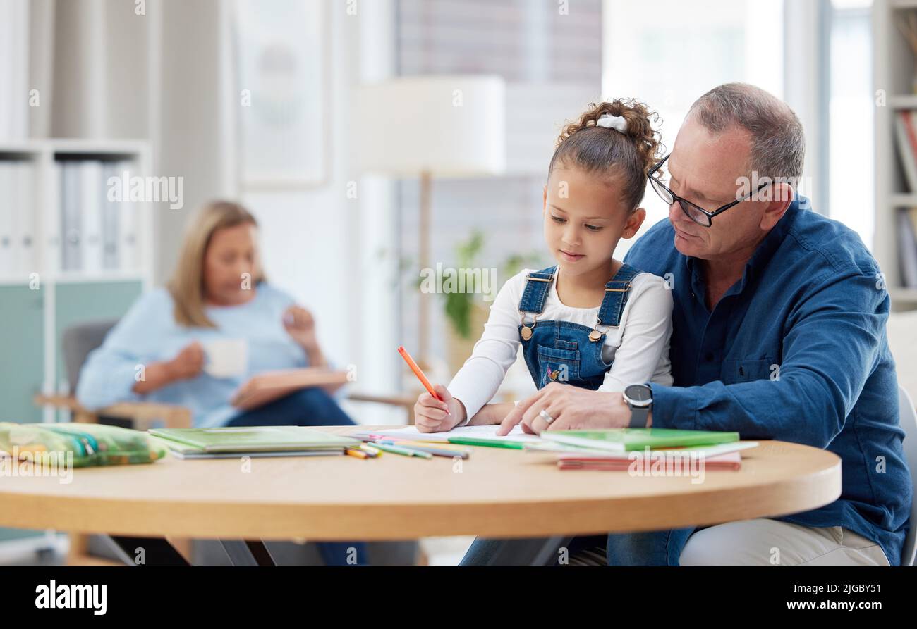 Make education a priority. a grandfather helping his grandchild with ...