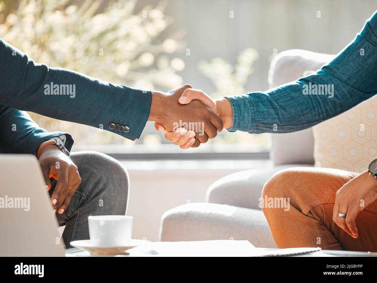 Hes ready to make a deal. two businessmen shaking hands in agreement ...