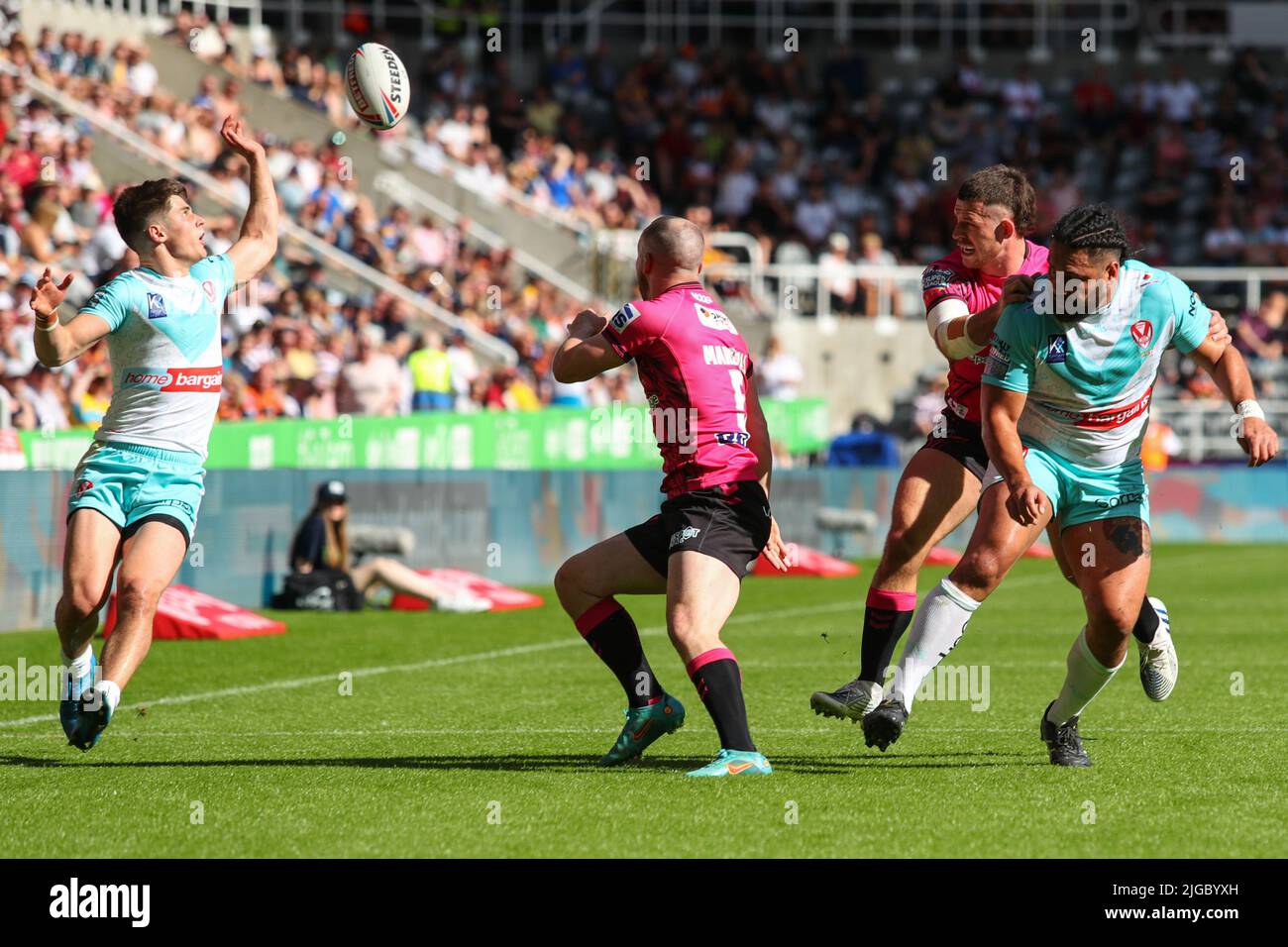 Konrad Hurrell #23 of St Helens makes a poor pass to Joe Bennison #27 ...