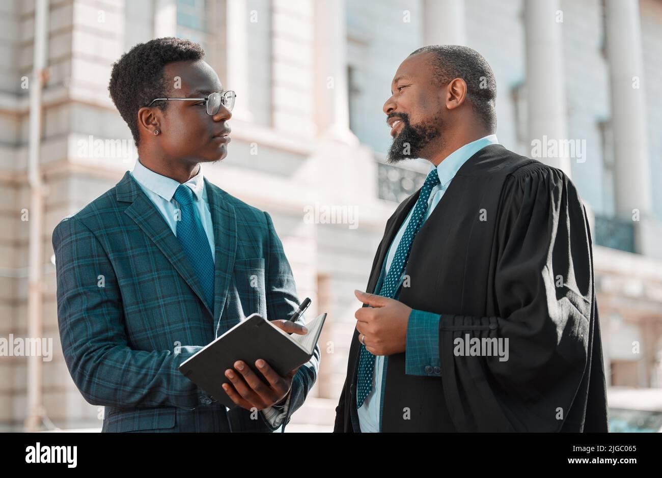 Learning from the best. two male lawyers talking in the city Stock ...
