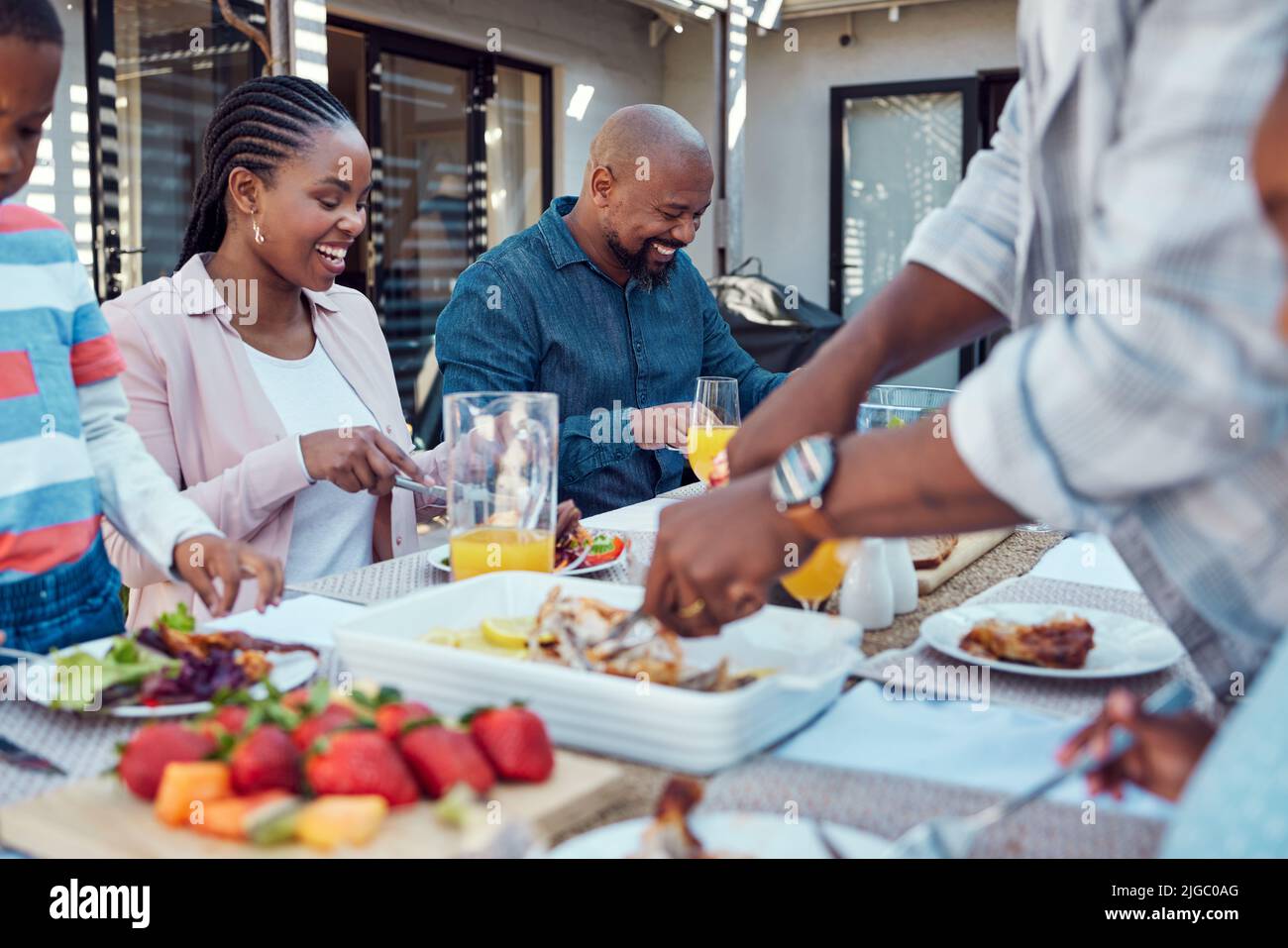 Lunch is served. a happy family having lunch together outside in the ...