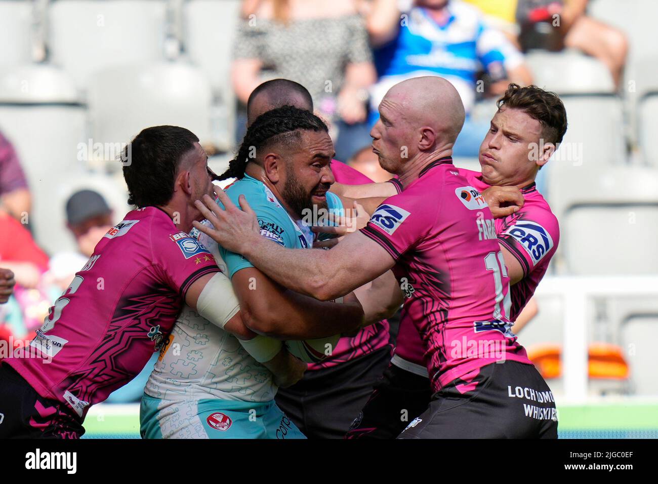 Konrad Hurrell #23 of St Helens is held by Willie Isa Liam Farrell #12 ...