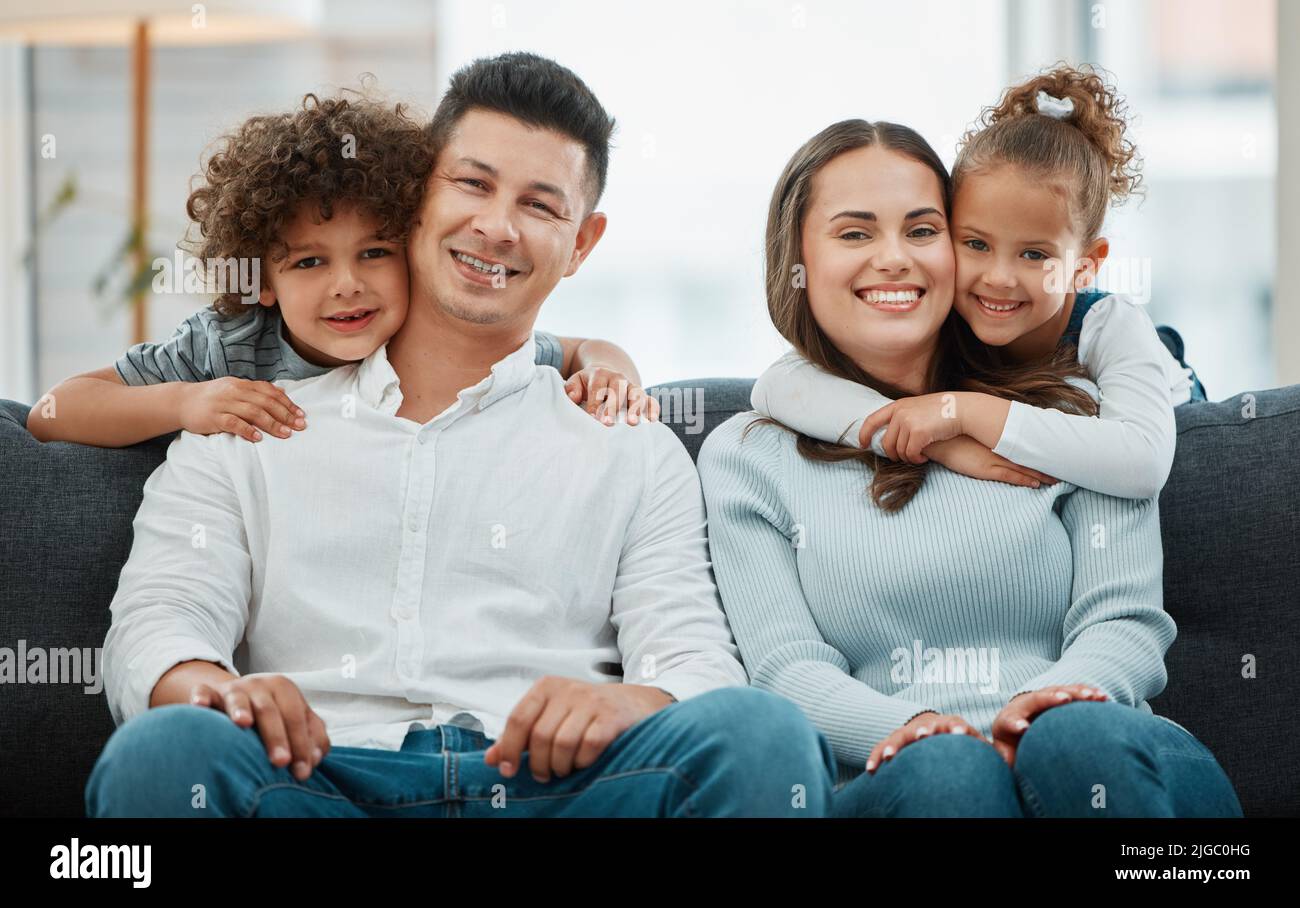 Our kids are our joy. a young couple being hugged by their children ...
