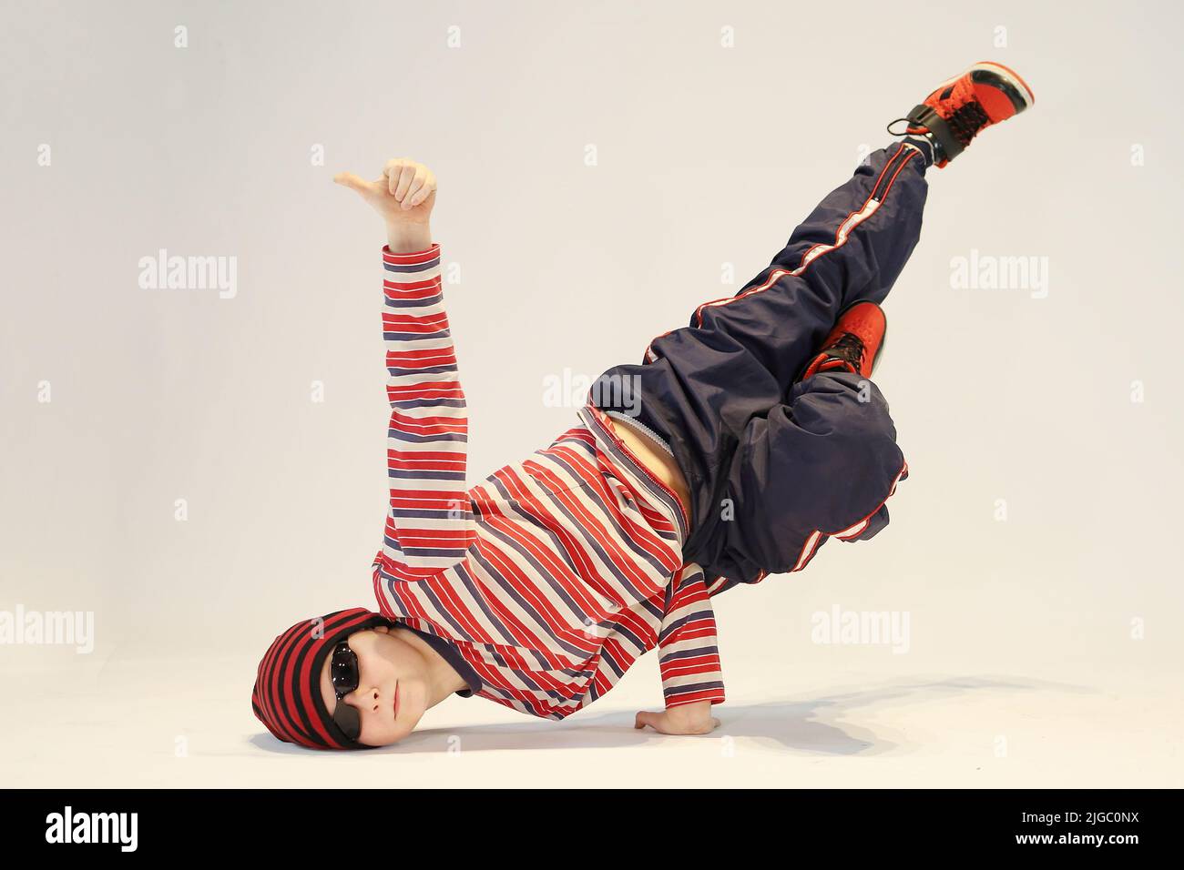 boy in breakdance position, difficult dance position, stands on one ...