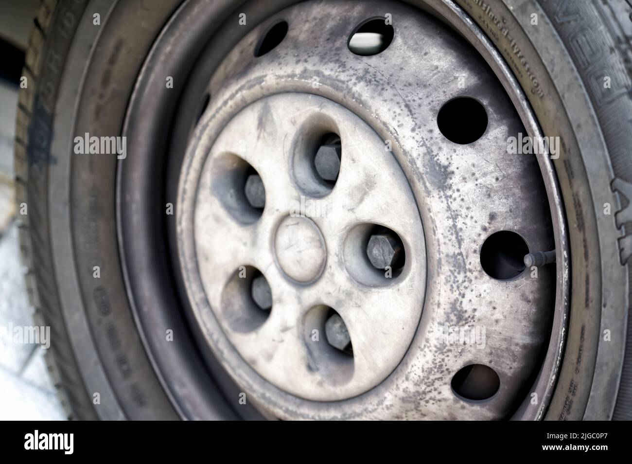 Close up of the old and damaged steel rim of a van and its tire Stock ...