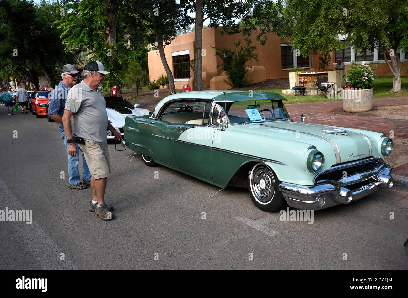 Car show visitors admire a 1956 Pontiac on display at a Fourth of July ...
