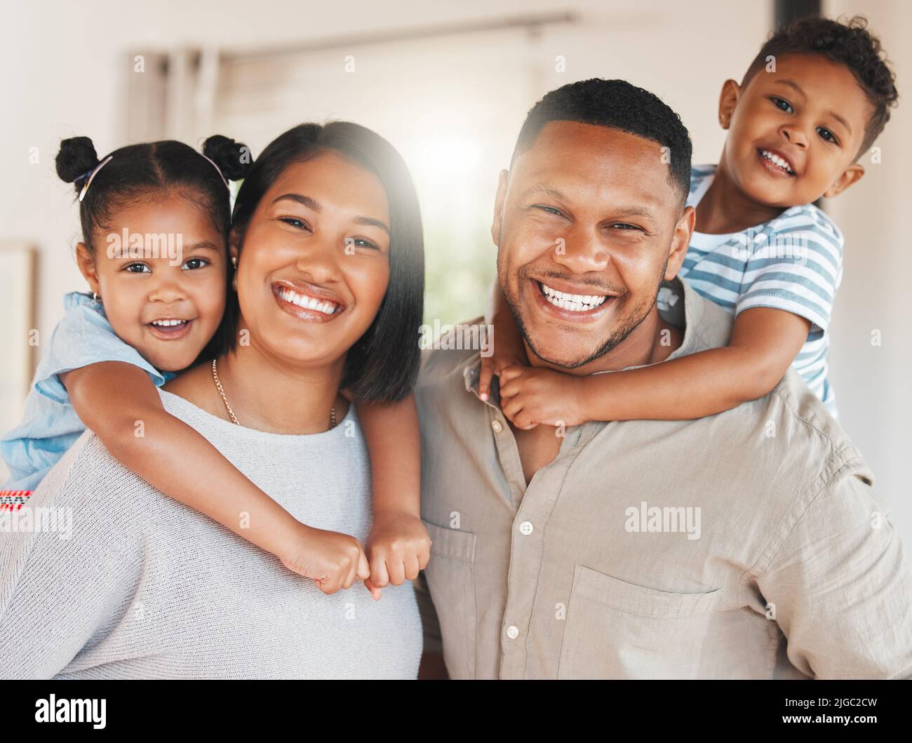 Bonded by love. Portrait of a beautiful young family bonding while ...