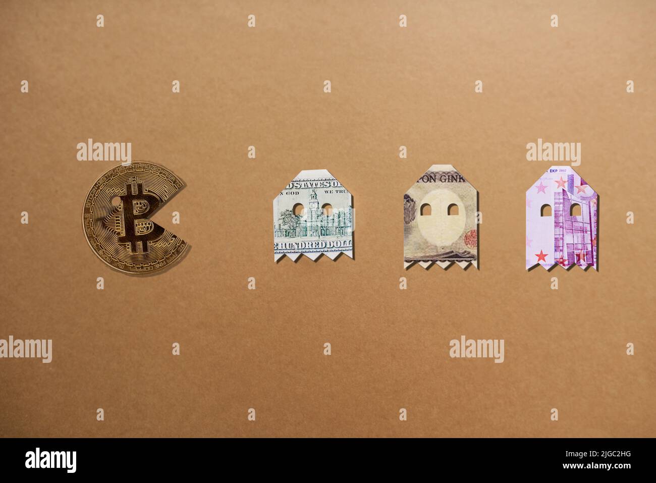 Money makes all the difference. Studio shot of bitcoin pacman chasing ...