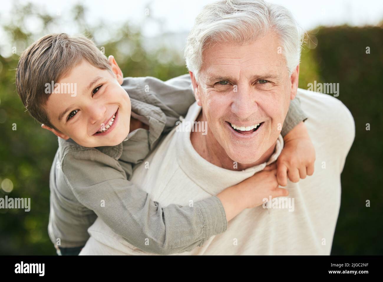 Is your granddad as cool as mine. a mature man carrying his son on his ...