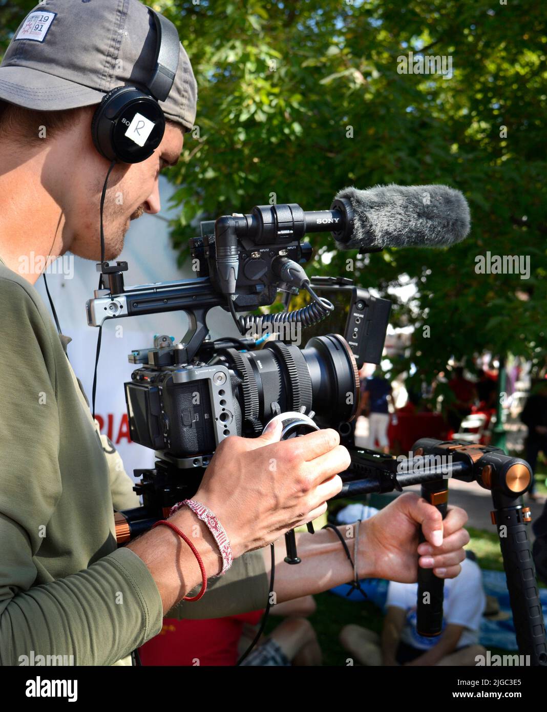 A cameraman uses a Sony digital camera and microphone outfit to film a ...