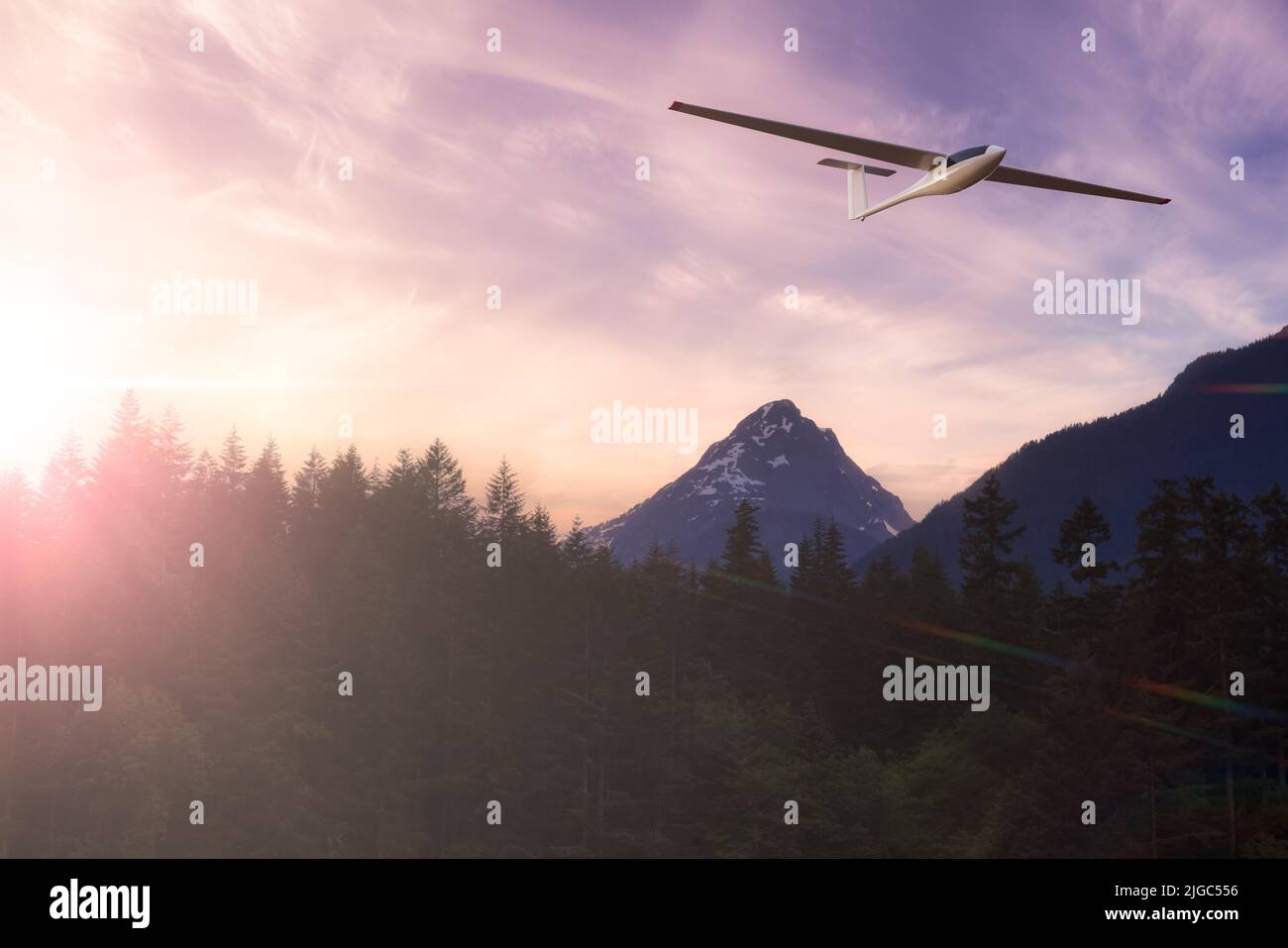 Glider flying over trees and mountains in Canadian Landscape Stock ...