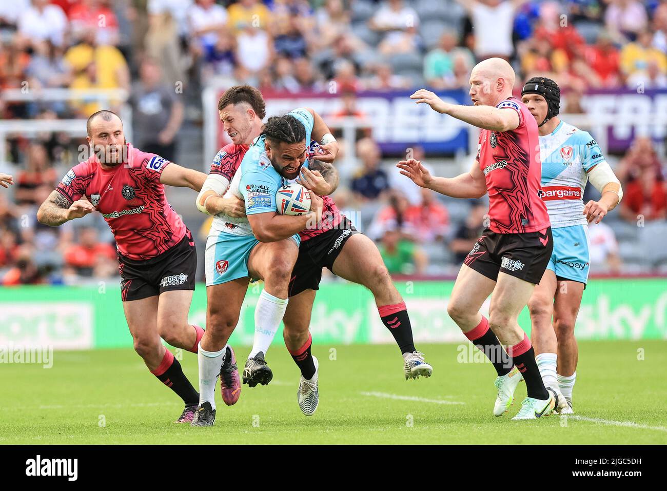 Konrad Hurrell #23 of St Helens is tackled by Cade Cust #6 of Wigan ...