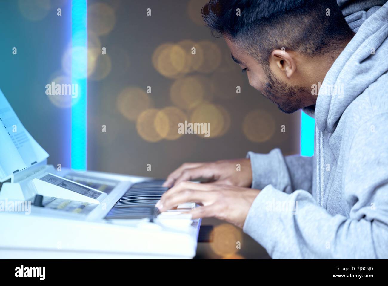 Hes so confident on the keyboard. a young man playing a piano during an ...