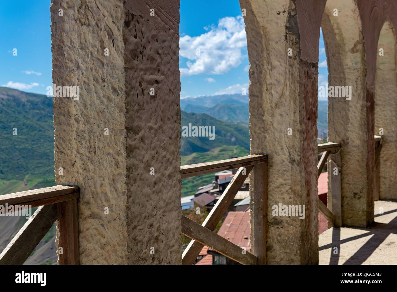 arched gallery along the facade of the house in the ancient mountain ...