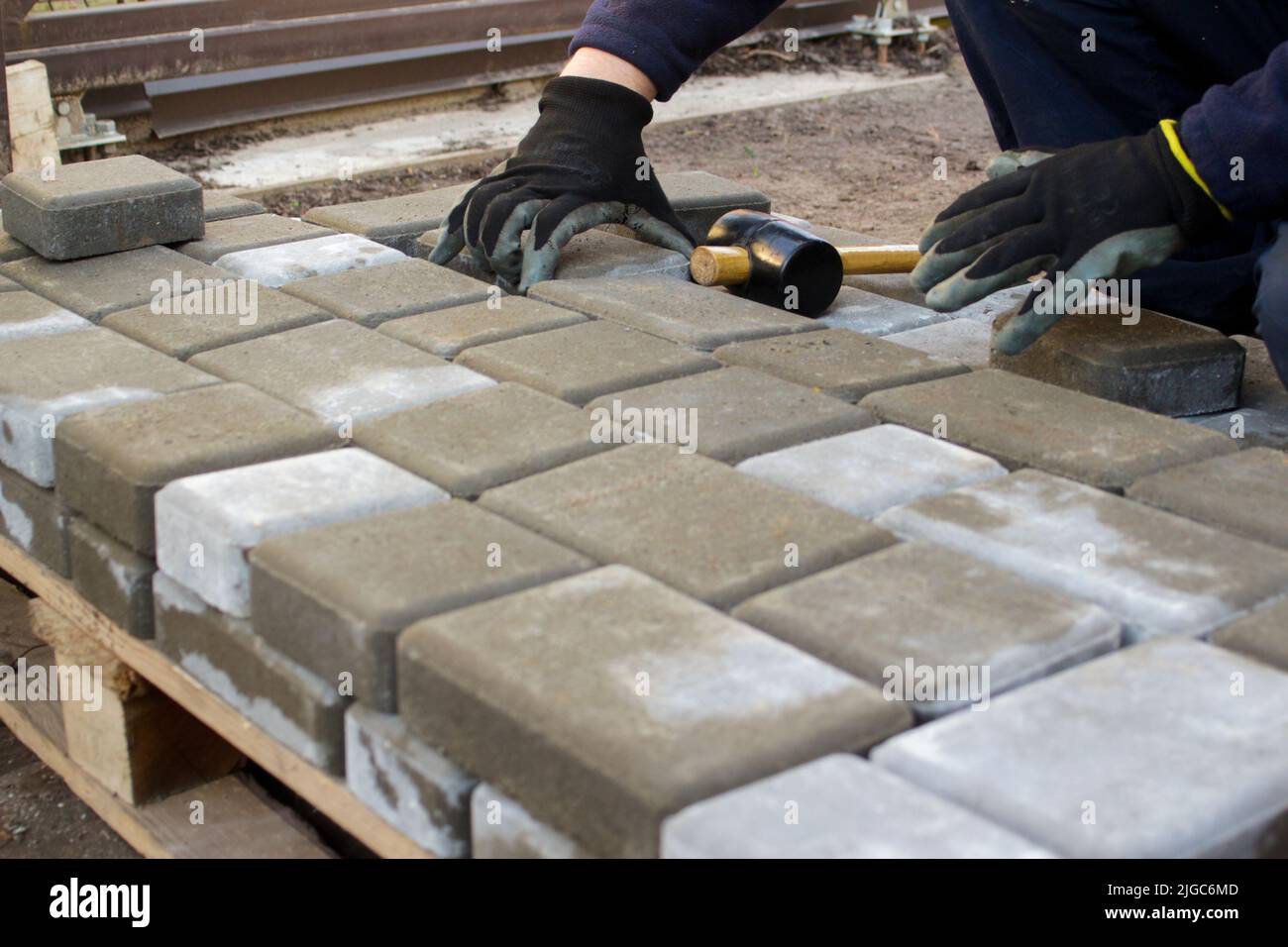 Defocus paver master. Man lays paving stones in layers. Garden brick ...