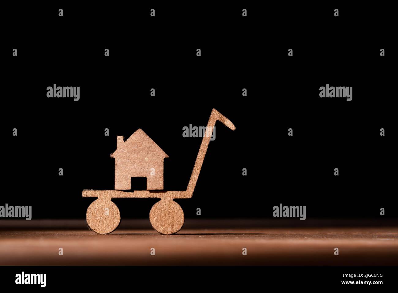 Cardboard cut-out representation of a shopping cart with a little house ...
