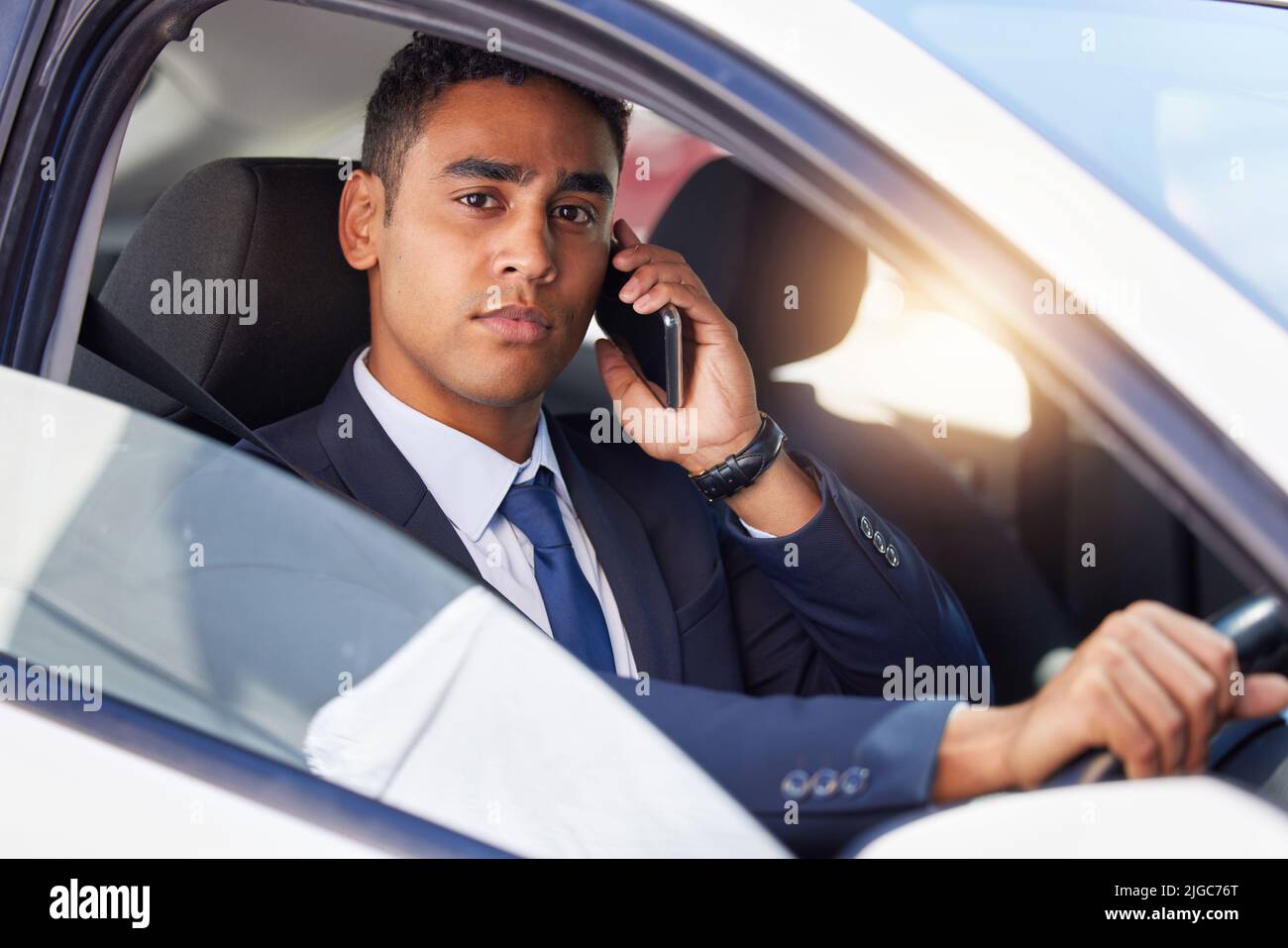 Making those important calls on the go. Cropped portrait of a handsome ...