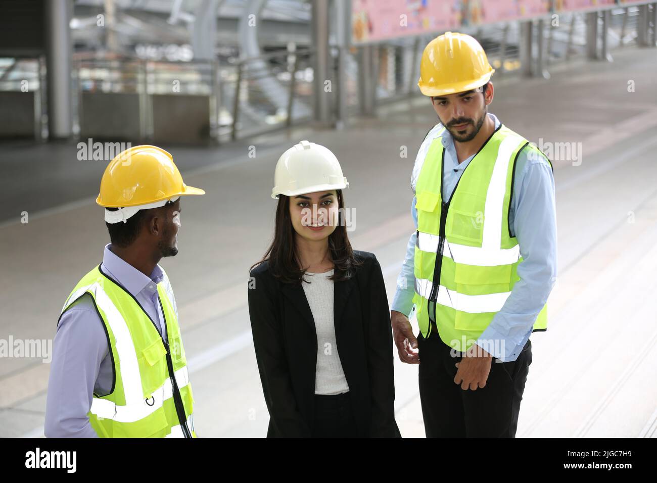 Architect Civil Engineer And Worker Looking At Plans And Blueprints