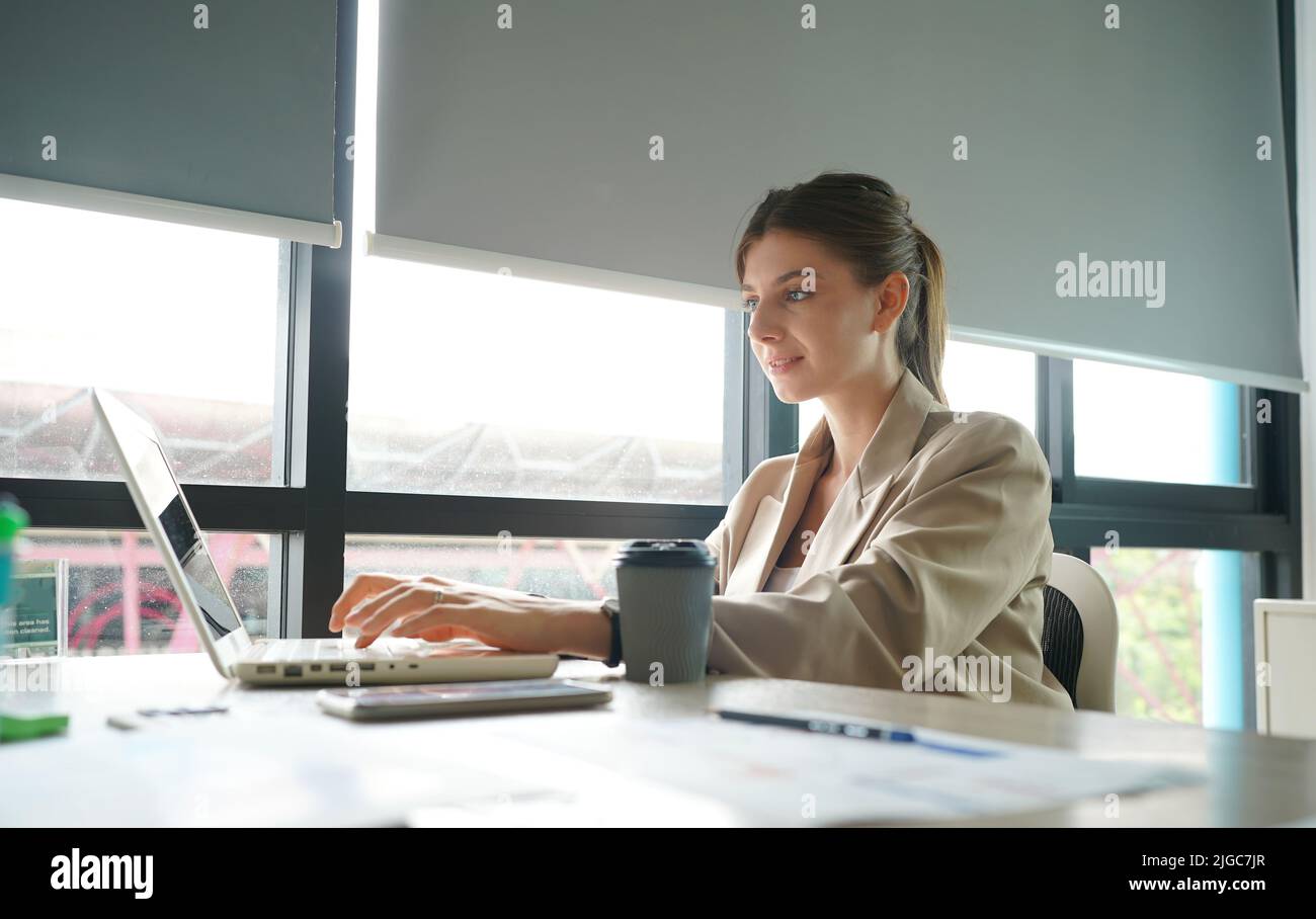 People using different devices at one table Stock Photo - Alamy