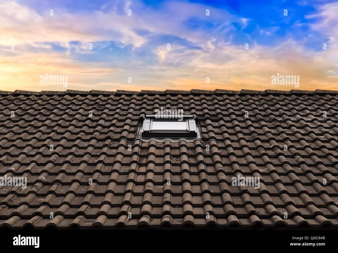 Roof window in velux style with dark roof tiles Stock Photo - Alamy