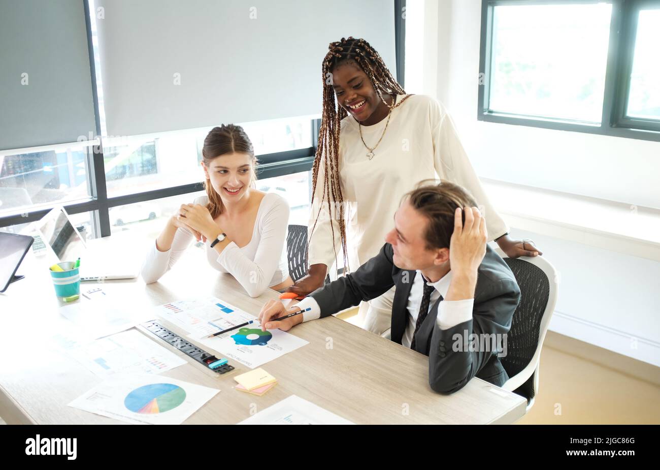 Business people discussing the charts and graphs showing the results of ...