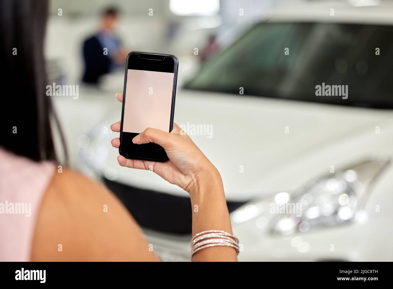 Im showing off my new ride on social media. a woman taking picture on ...