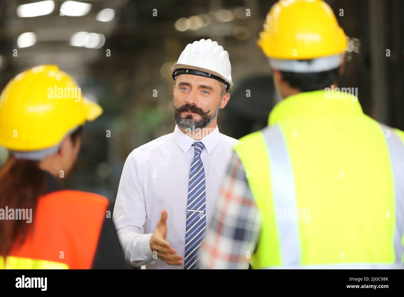 Architect, civil engineer and worker looking at plans and blueprints ...