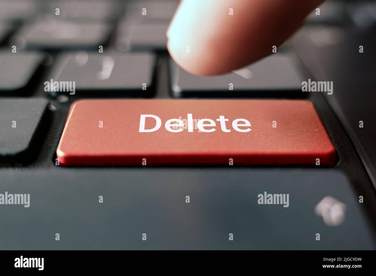 male finger pressing red delete black keyboard button Stock Photo - Alamy