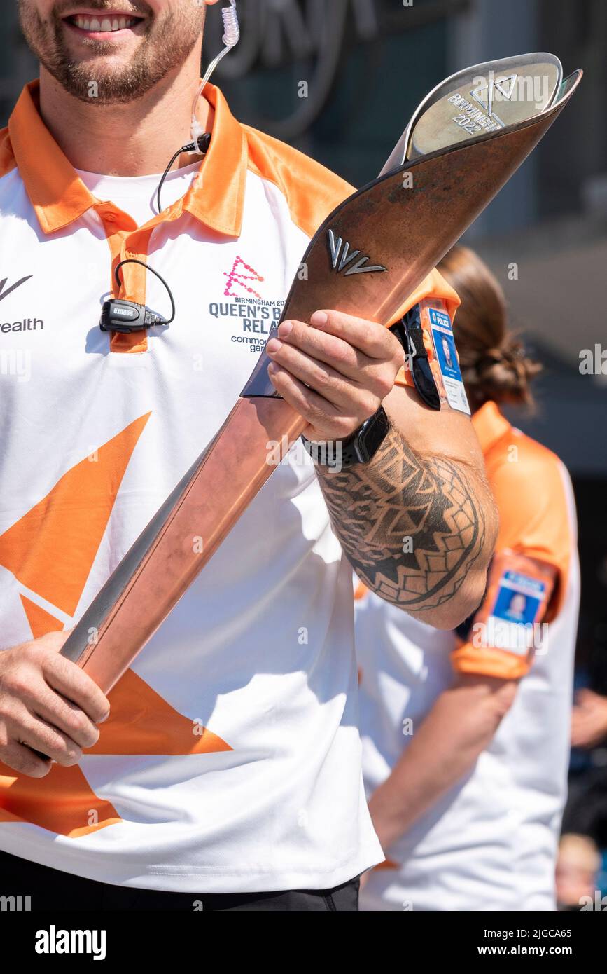 Commonwealth Games Birmingham 2022 baton in the hands of a police ...