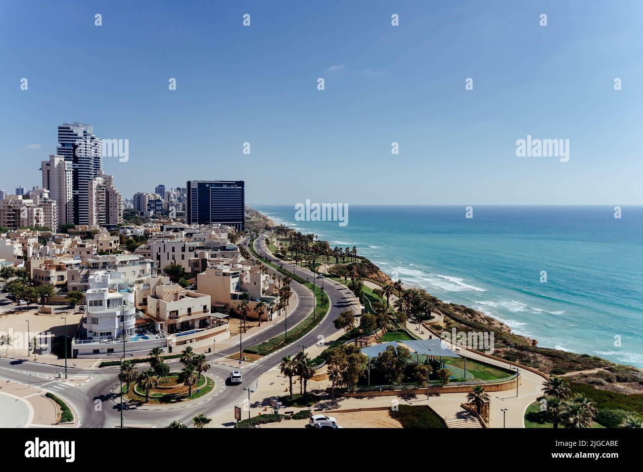 An aerial view of cityscape Netanya surrounded by buildings near lake ...