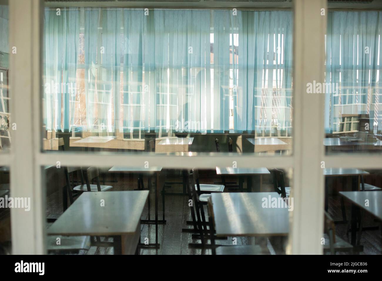 Details of interior of school. Desks in school behind glass. Study ...
