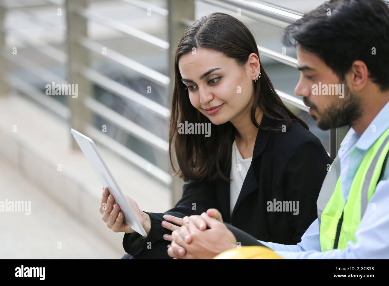 Architect Civil Engineer And Worker Looking At Plans And Blueprints