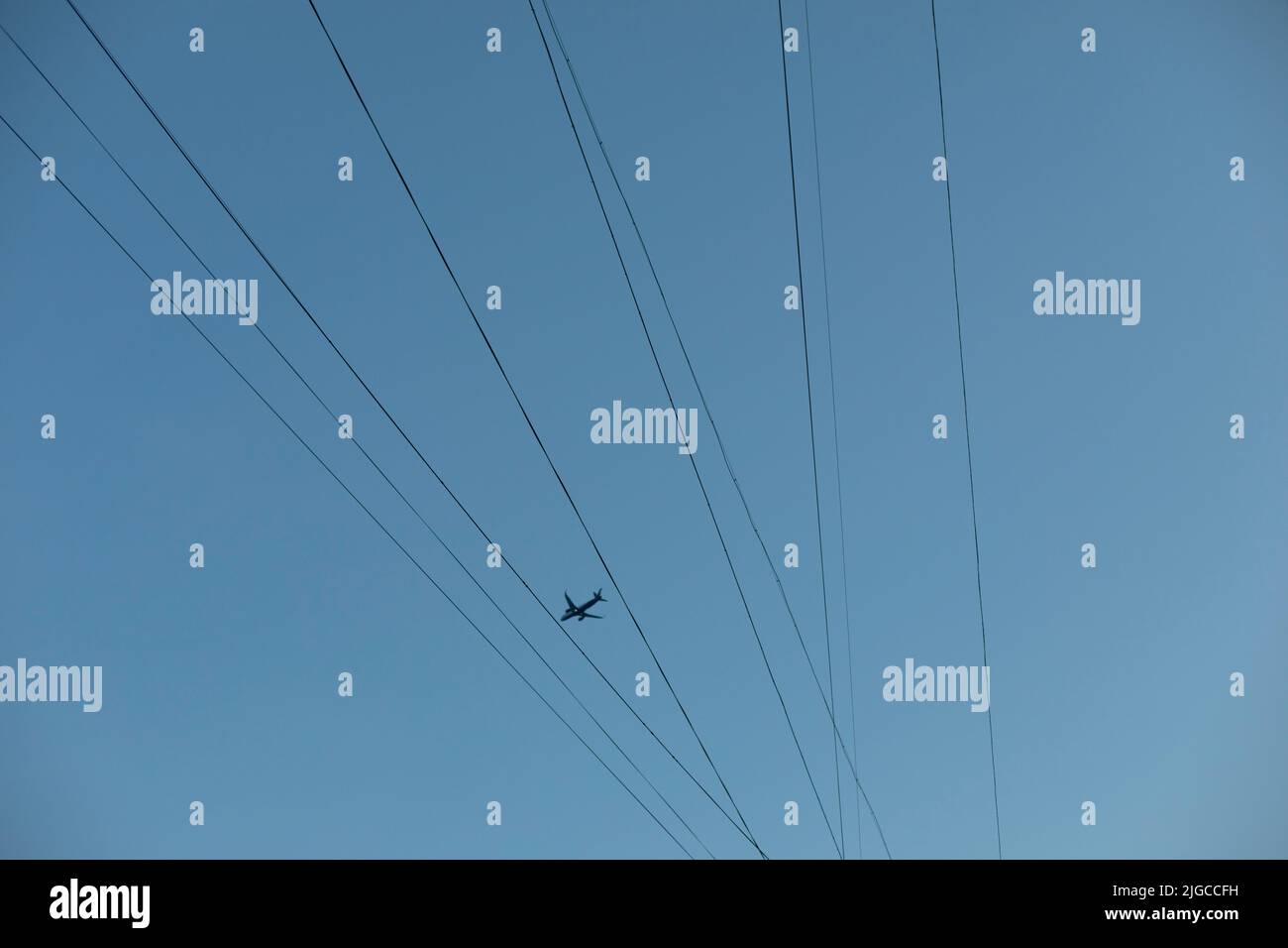 Wires in sky. Something flies across sky. Thin wires Stock Photo - Alamy