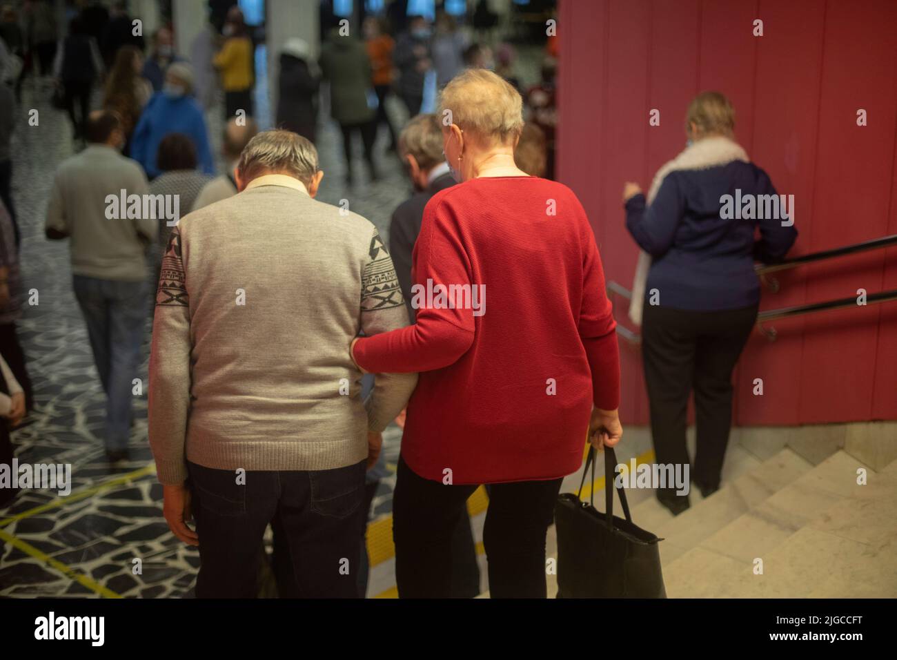 Elderly people leave hall. Old people go to meet veterans. People of ...
