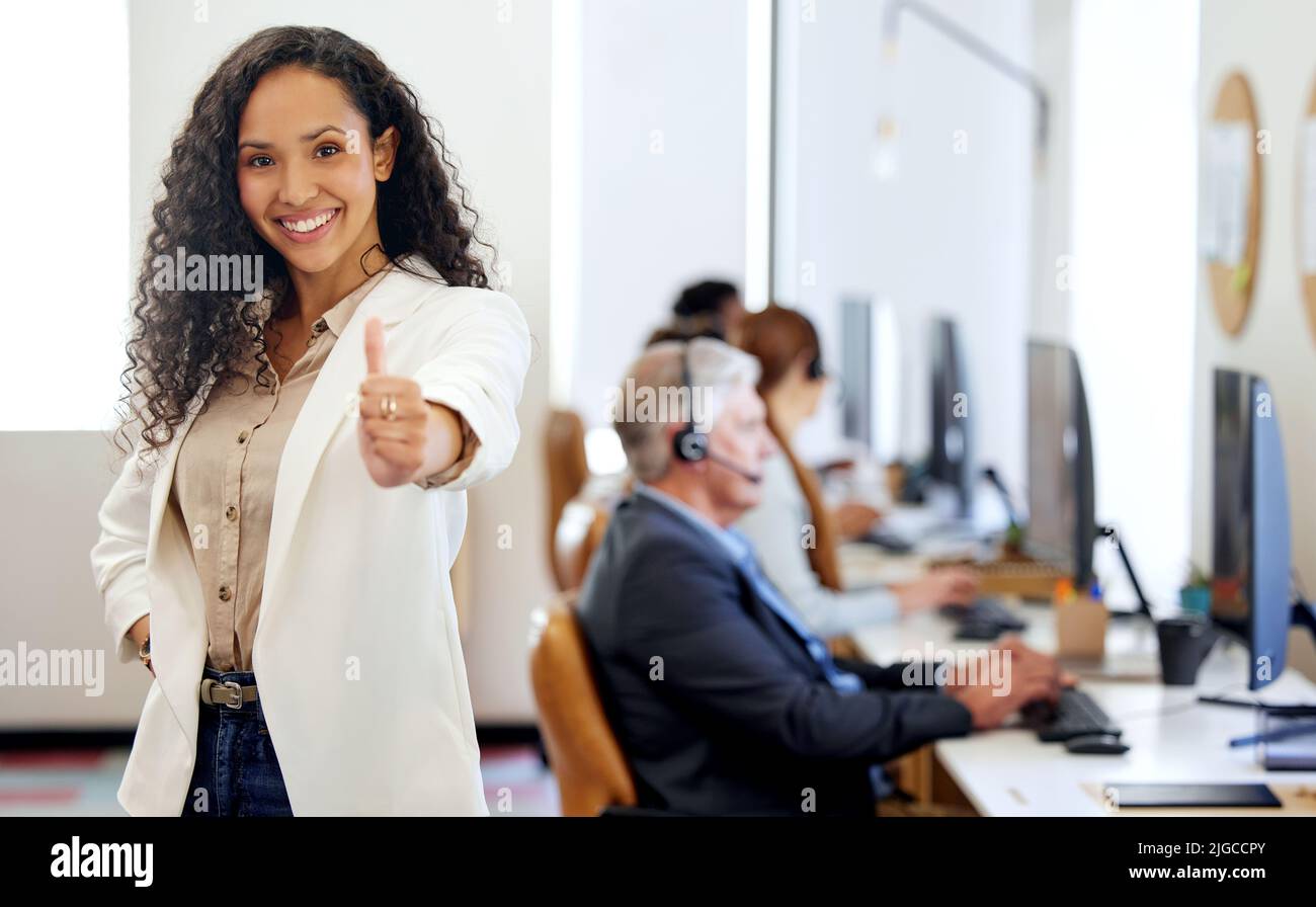 Weve got your call. Portrait of a young businesswoman showing thumbs up ...