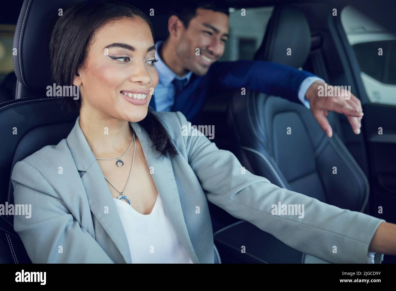 Shes looking for a new ride. an attractive young woman sitting in a new ...