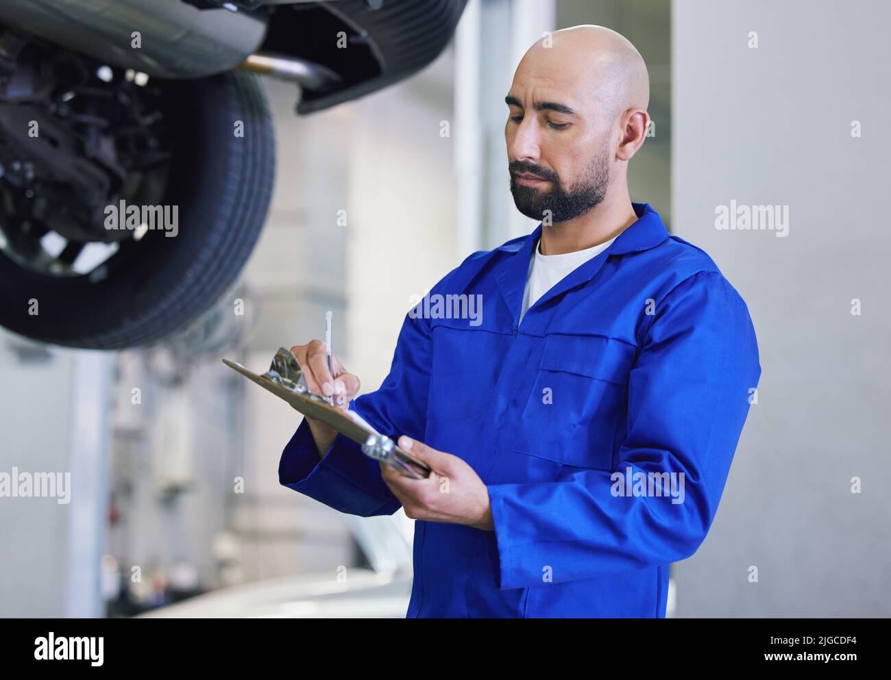 Safety is his number one concern. a handsome young male mechanic ...