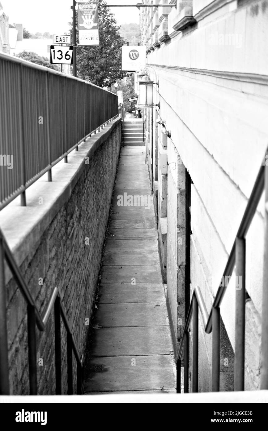 A vertical shot of staircases going down surrounded by buildings in ...