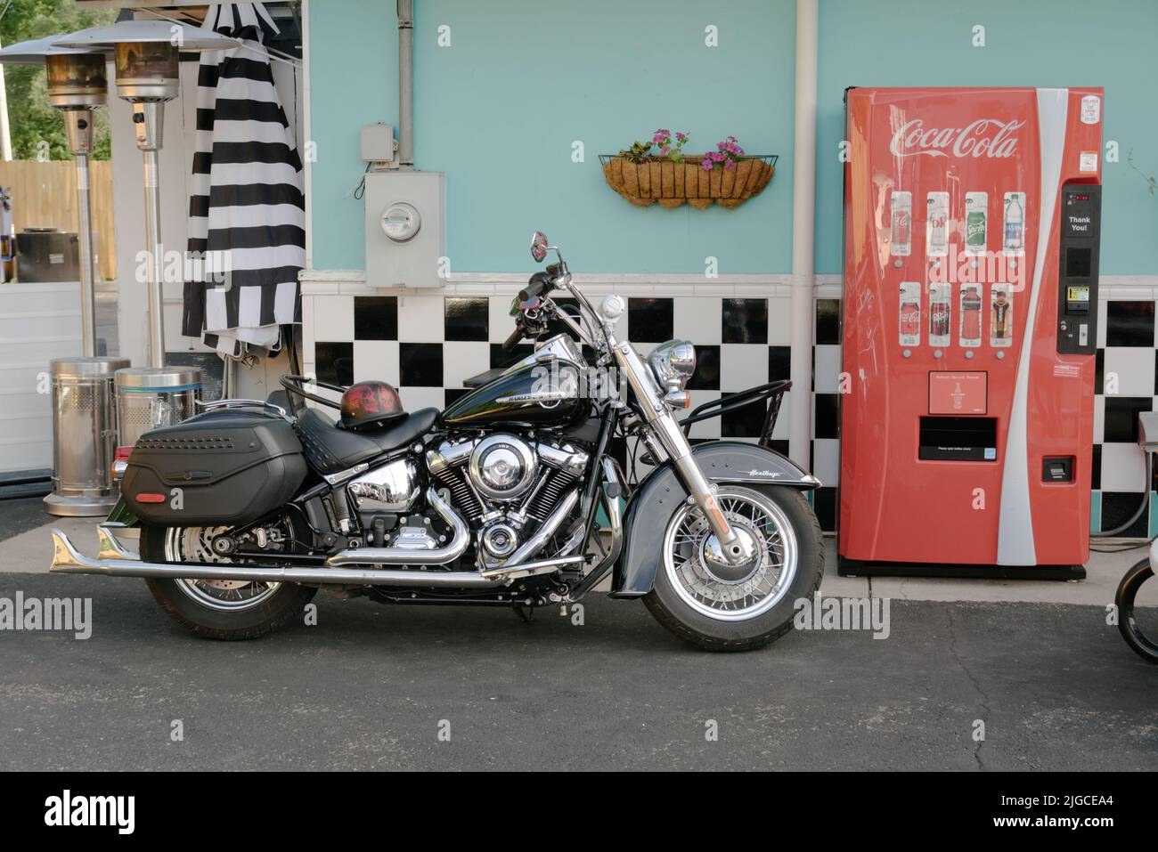 A closeup shot of Harley Davidson motorcycle with modern Coca-Cola ...