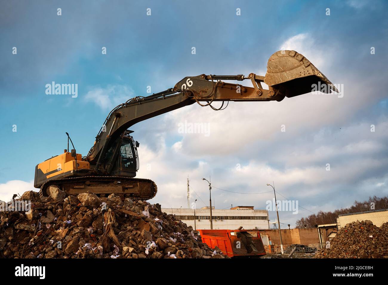 Building excavator on concrete pieces at demolition site Stock Photo ...