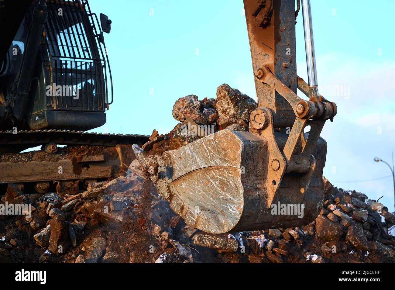 Scoop of building excavator full of concrete stone leftovers Stock Photo - Alamy