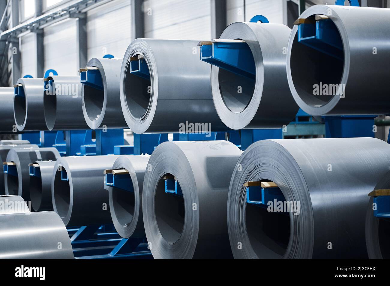 Large rolls of electrical transformer steel hang on rack Stock Photo ...