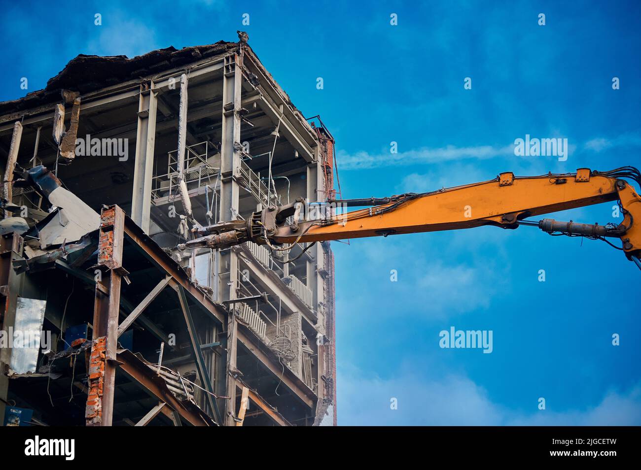 Hydraulic cutter on crane rig destroys industrial building Stock Photo ...