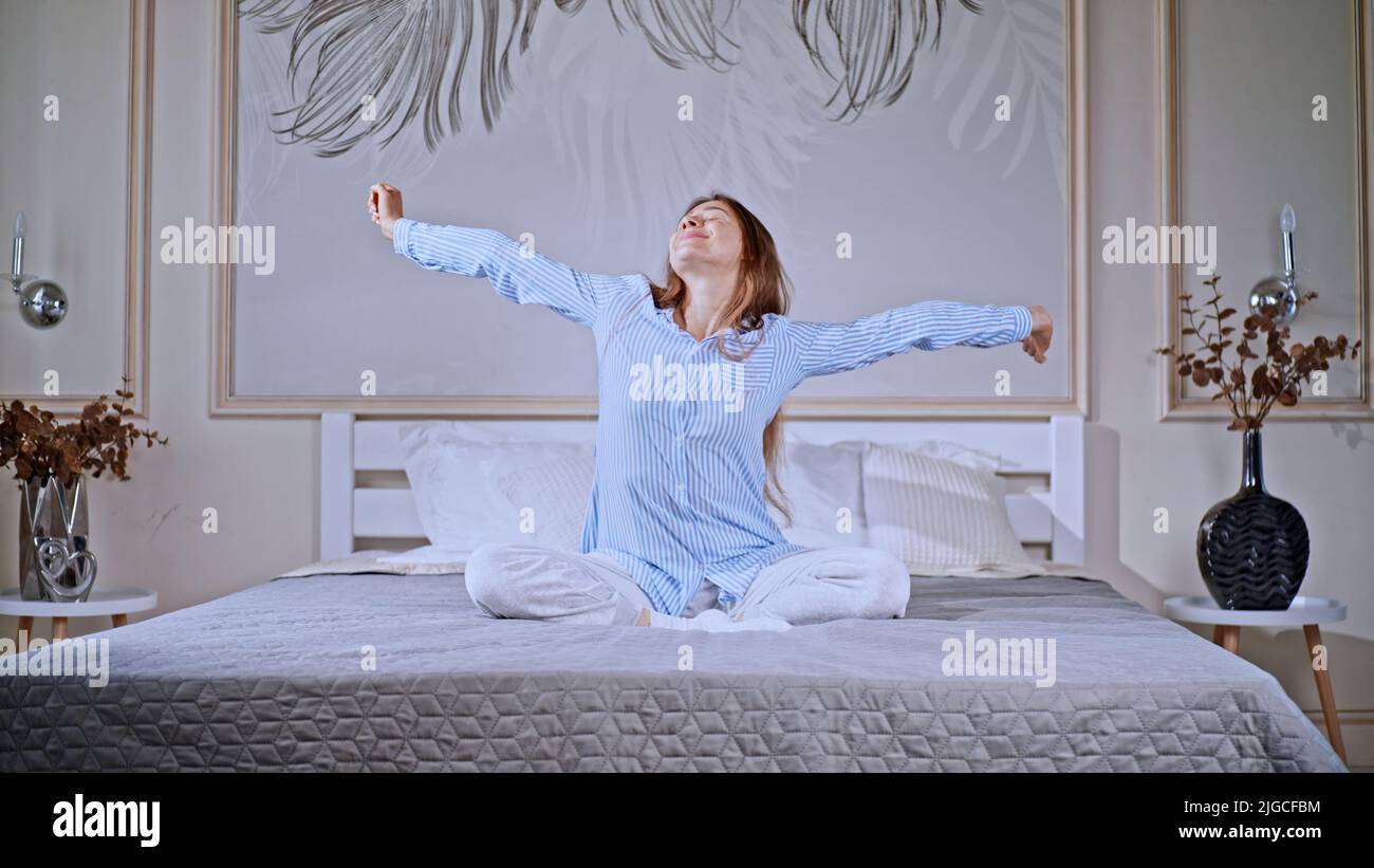 A young woman stretching in bedr Stock Photo - Alamy