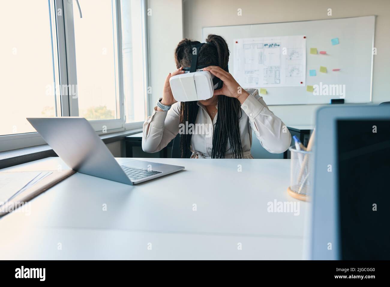 Company employee using VR reality in workplace Stock Photo - Alamy