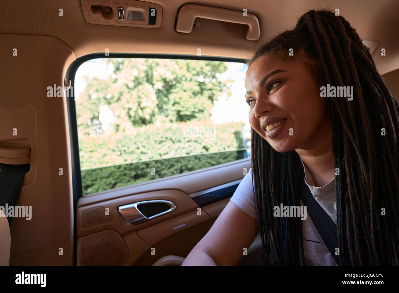 Young resilient female passenger enjoying car travel Stock Photo - Alamy
