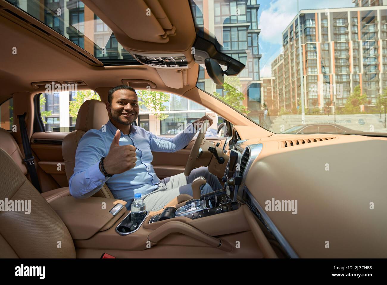 Motorist seated in his car cabin showing gesture of approval Stock ...